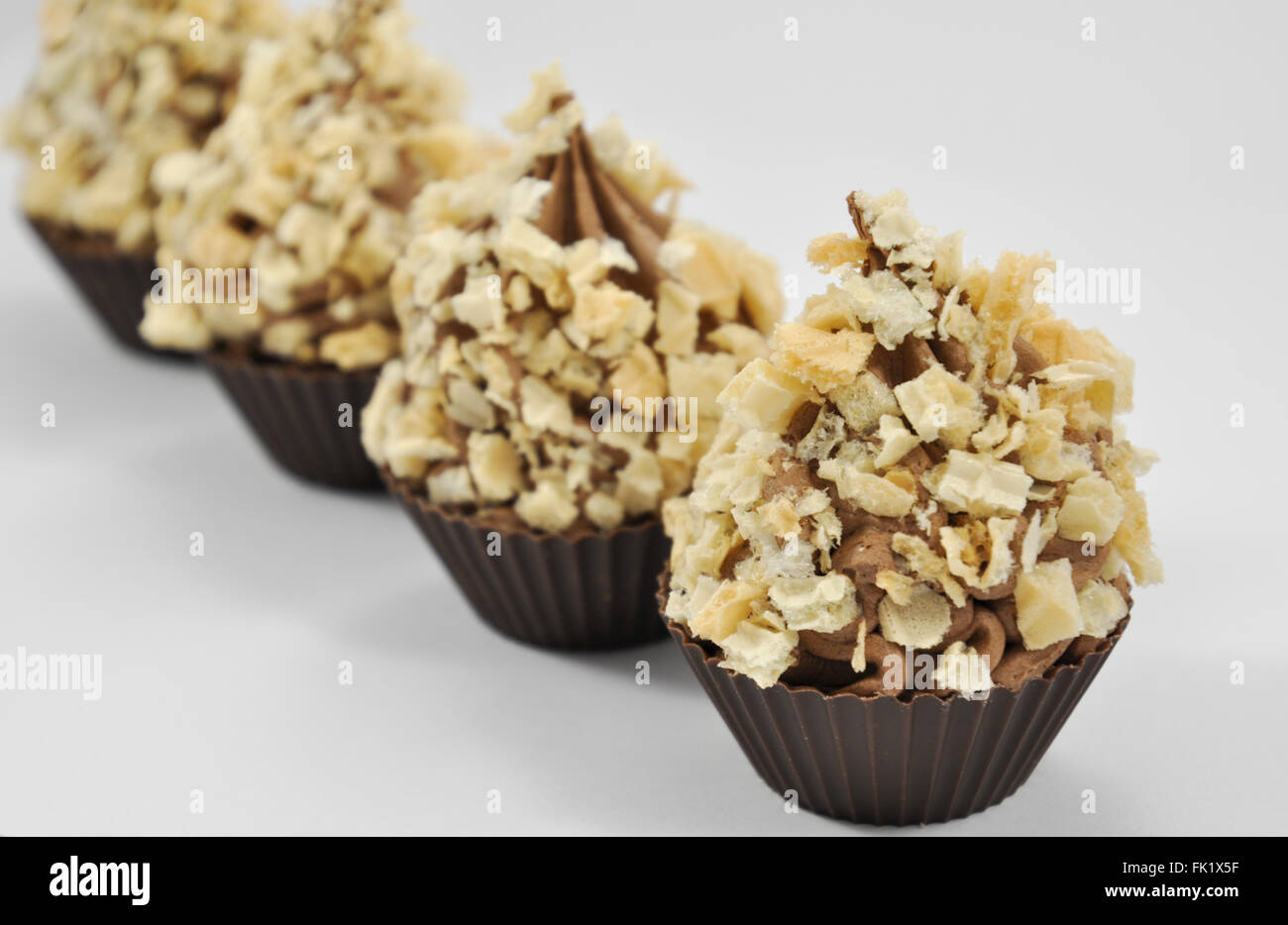 Group of chocolate cakes standing in a row on a white background Stock ...