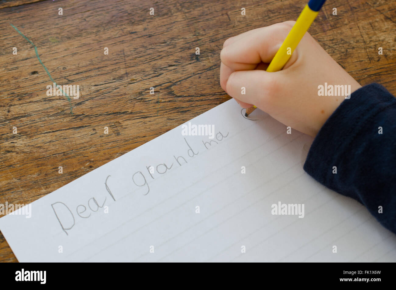 Child writing with pencil hi-res stock photography and images - Alamy