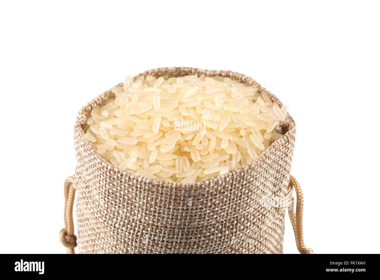 Rice in a sack and spilled on a white background Stock Photo - Alamy