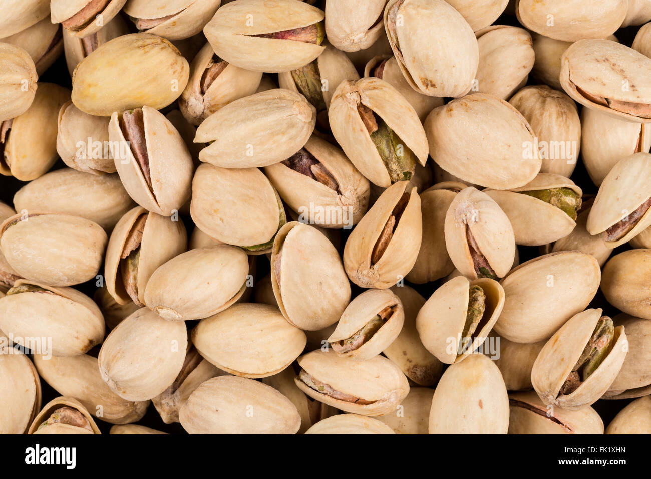 Pistachio nuts arranges as background close up Stock Photo - Alamy