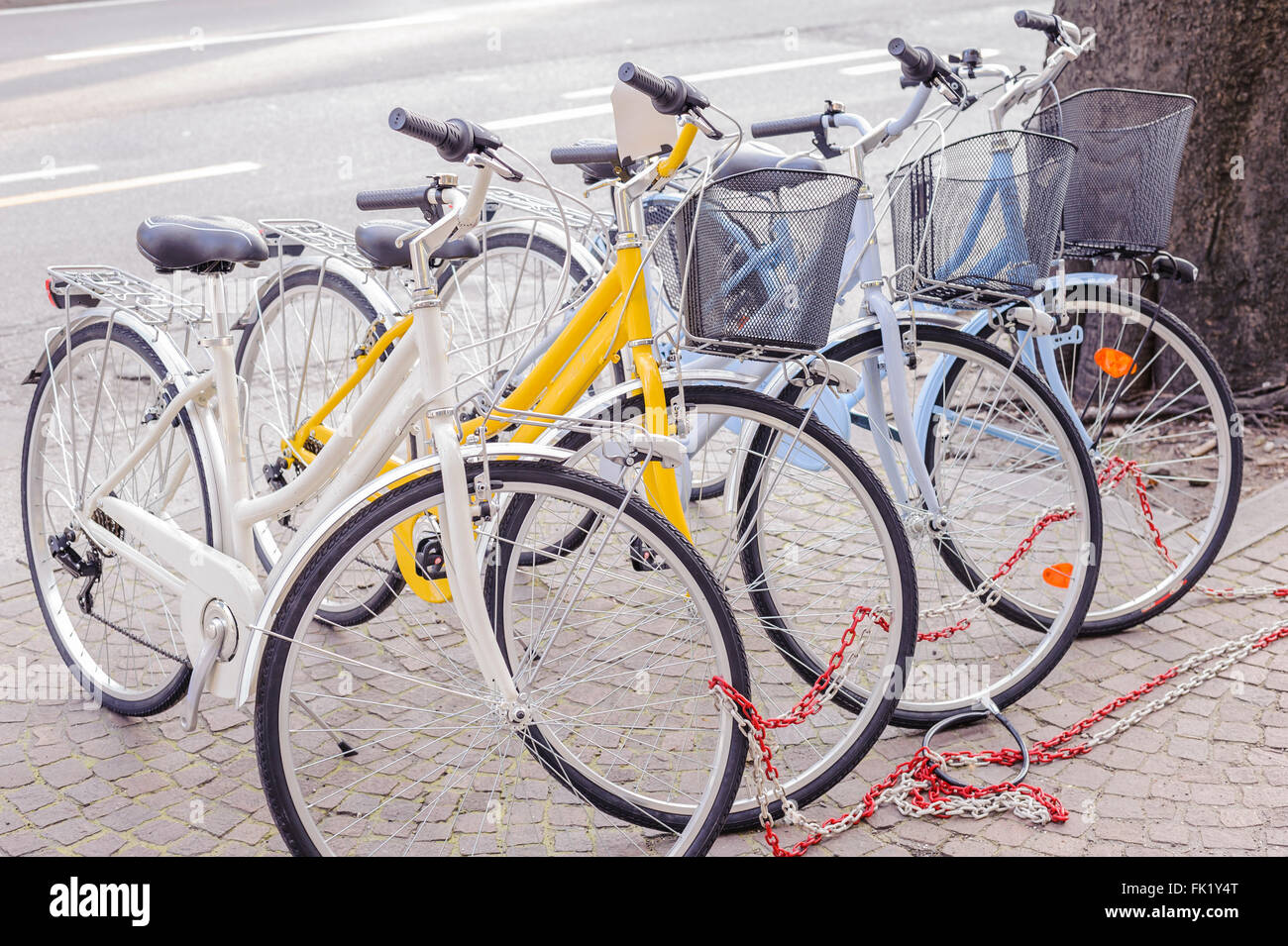Four parked bicycles on the sidewalk, chained together Stock Photo - Alamy