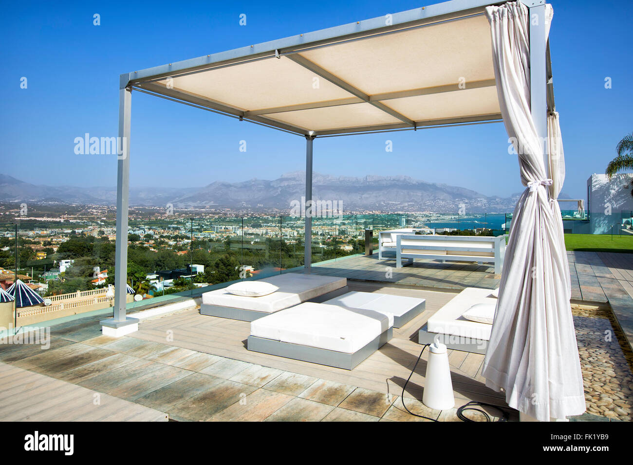 Swimming pool area with white sun beds at the modern resort Stock Photo ...