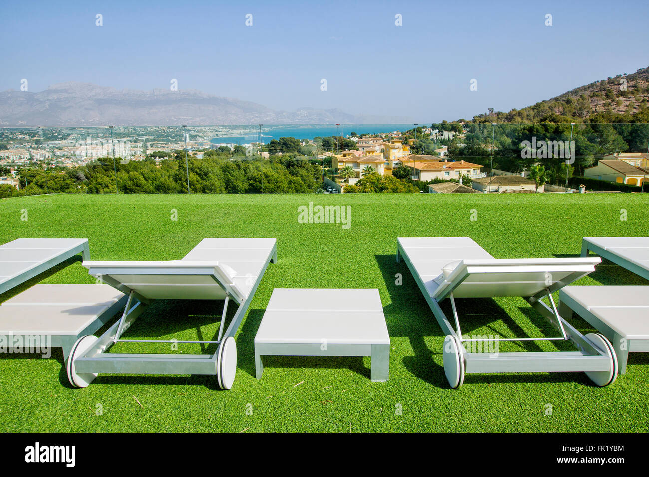 Swimming pool area with white sun beds at the modern resort Stock Photo ...
