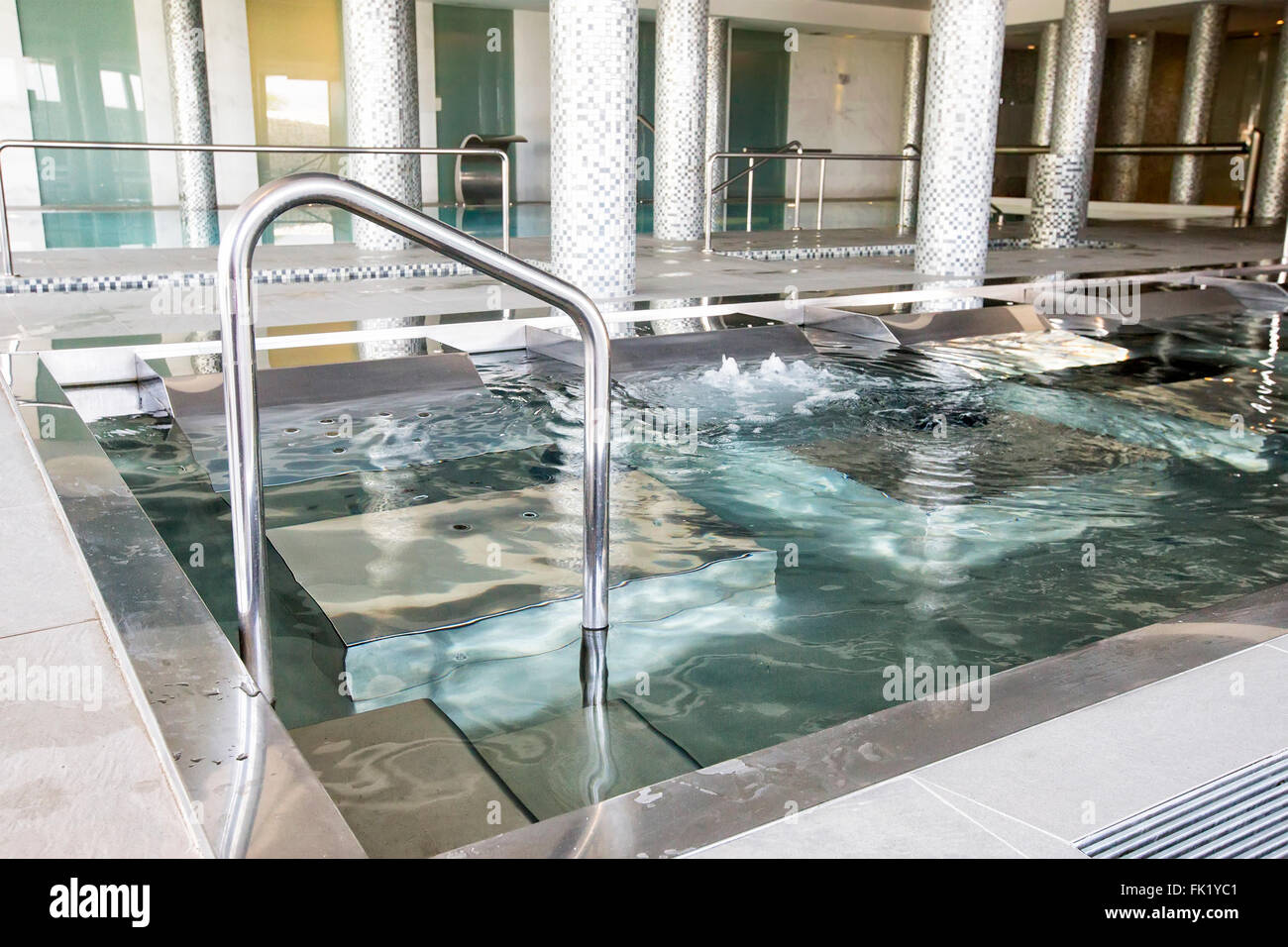 Empty interior swimming pool with relaxation area in a modern hotel ...