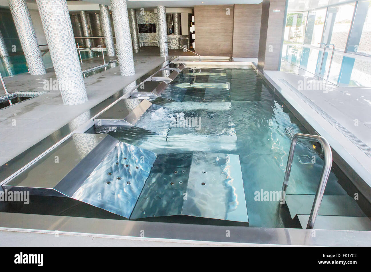 Empty interior swimming pool with relaxation area in a modern hotel ...