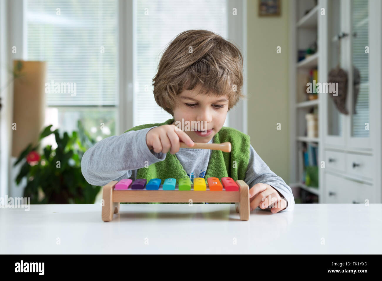 Cute little playing on xylophone. Musical education, help recognize ...
