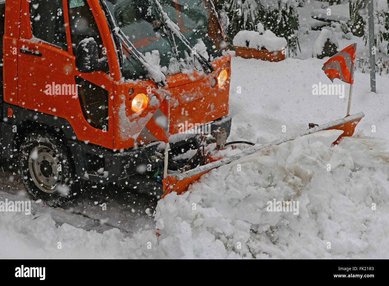 Detail of snow plow truck and blade in action during a heavy snow storm ...