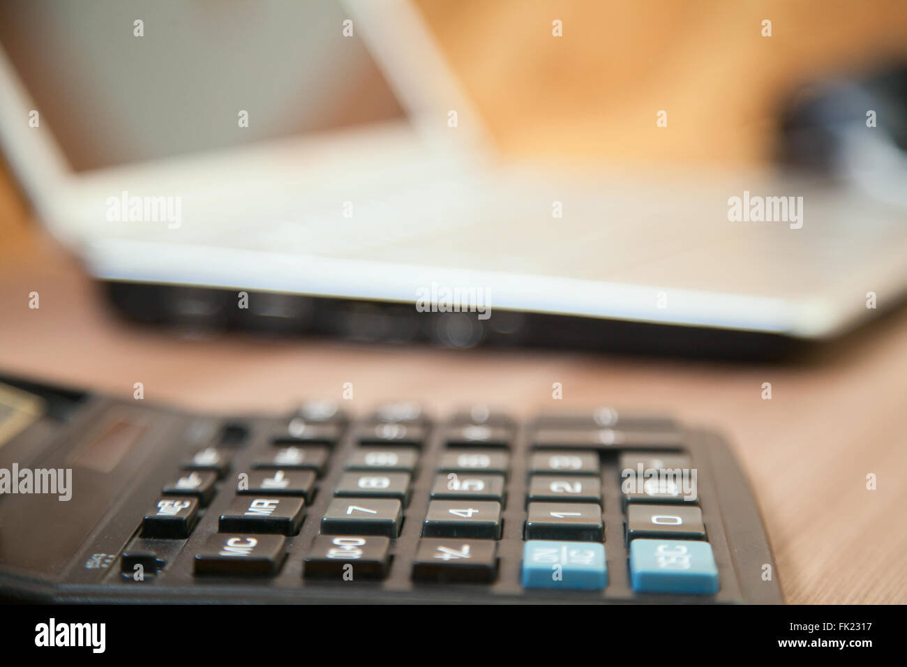 Calculator and laptop on the table Stock Photo - Alamy