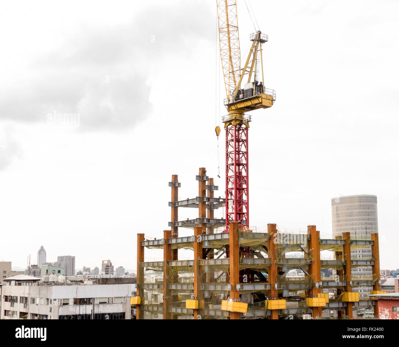 Big building being constructed with crane on top Stock Photo - Alamy