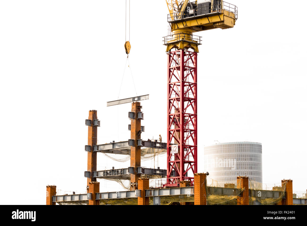 Big building being constructed with crane on top Stock Photo - Alamy