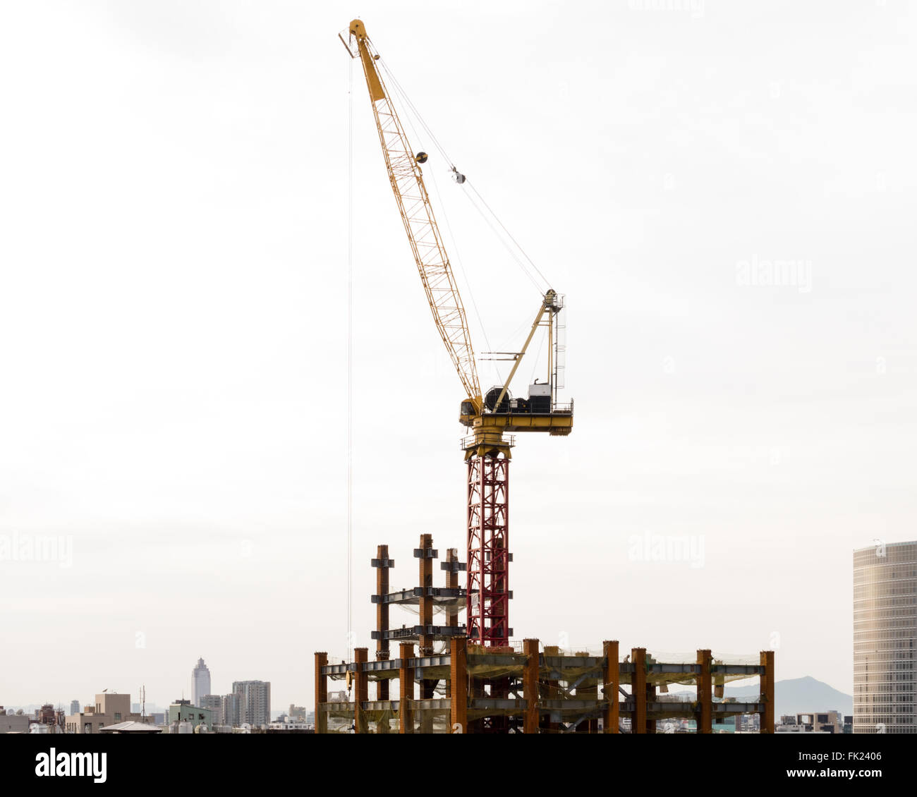 Big building being constructed with crane on top Stock Photo - Alamy