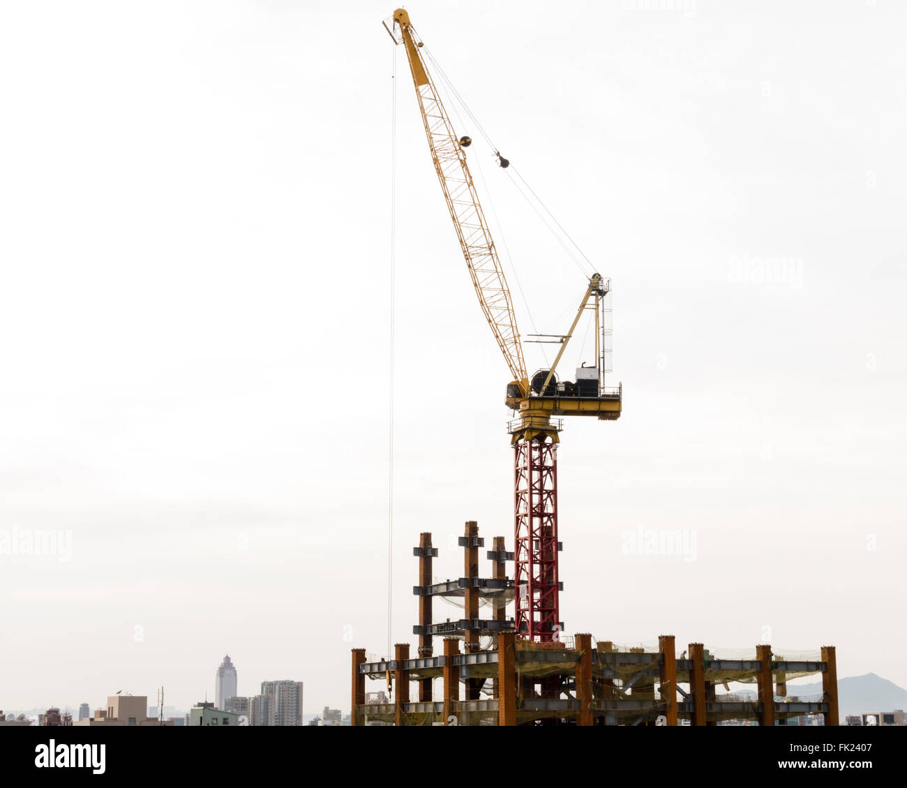 Big building being constructed with crane on top Stock Photo - Alamy