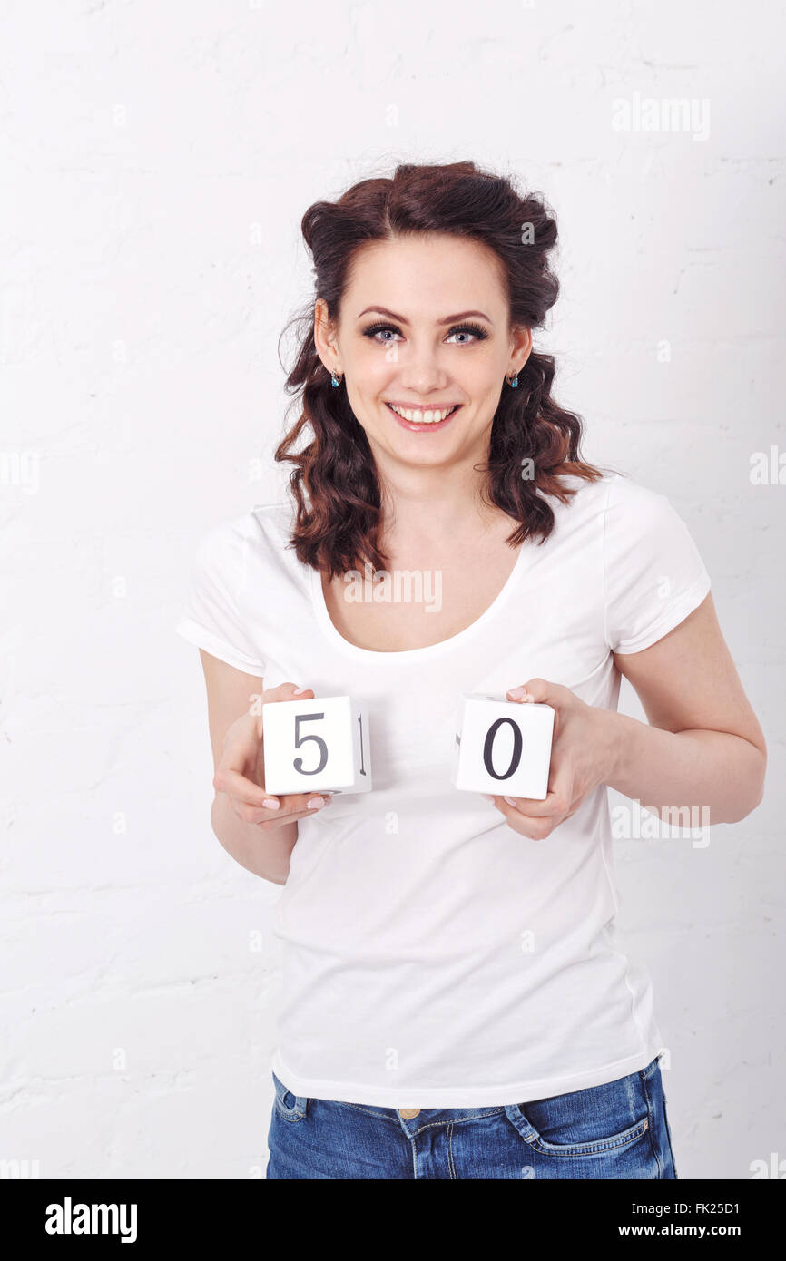 Young cute girl smiling and holding a number fifty hands. Girl dressed ...