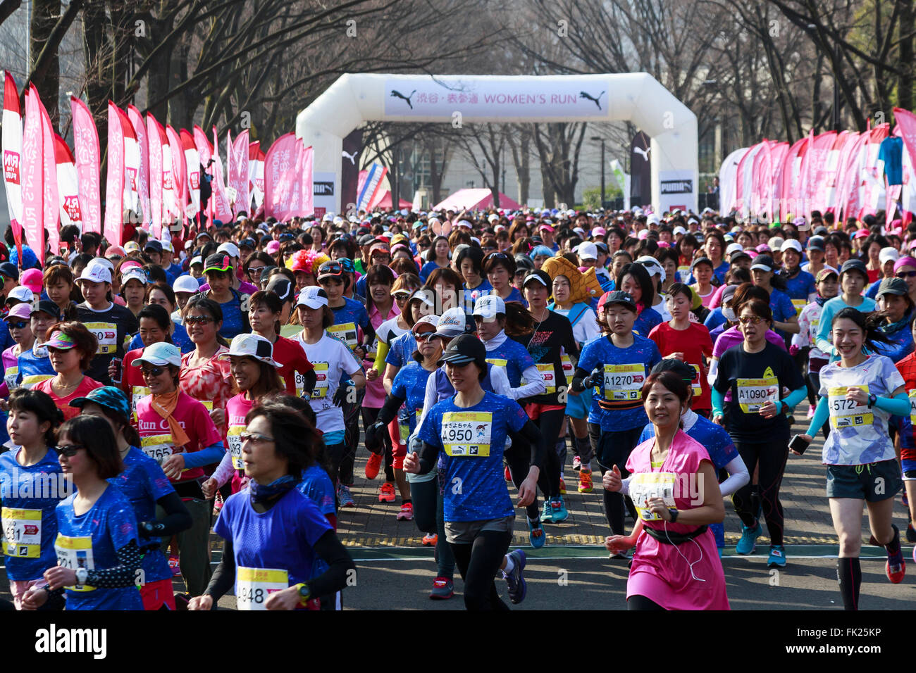 Runners cross the start line at the beginning of the Shibuya Omotesando ...