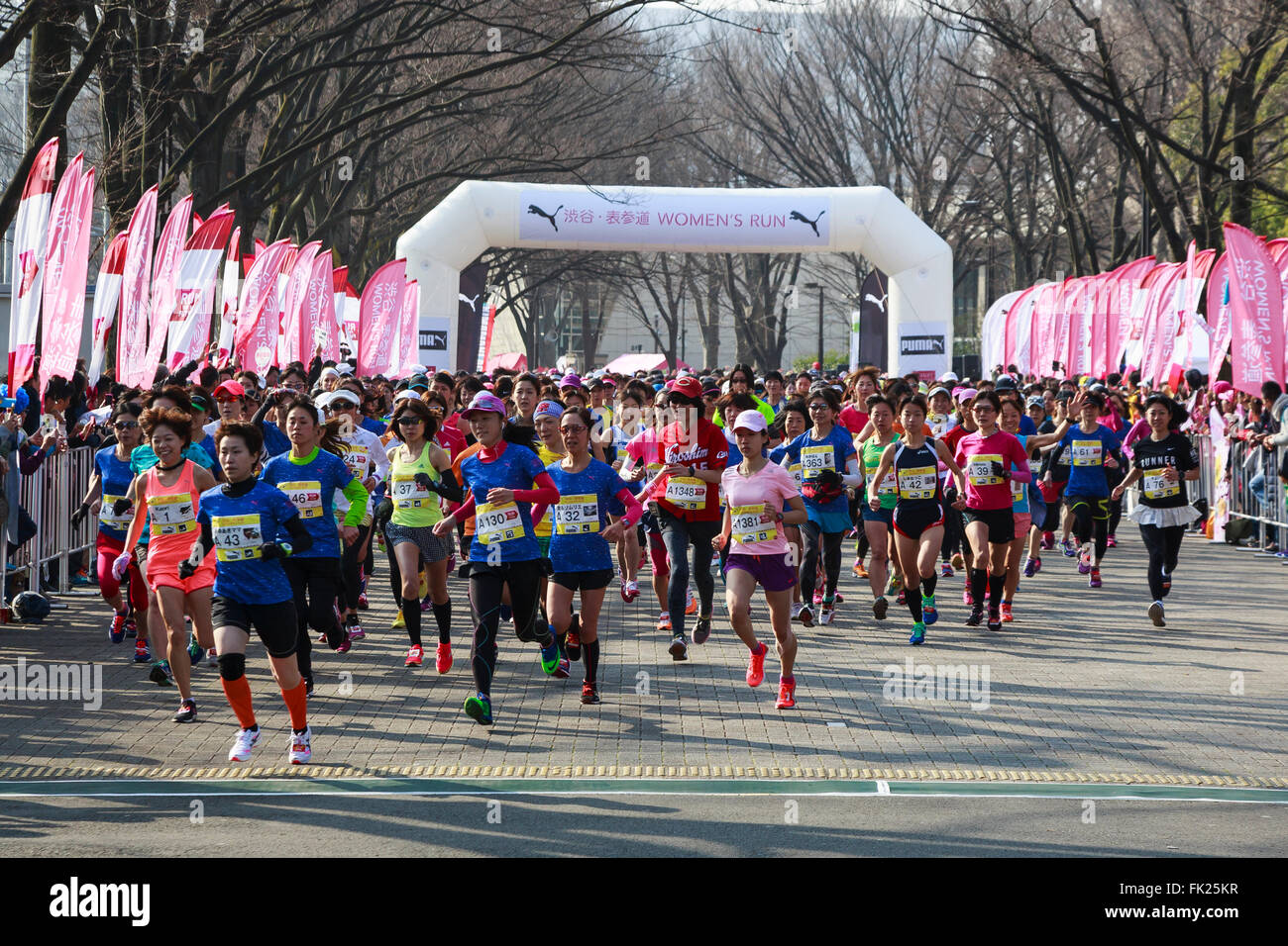 Runners cross the start line at the beginning of the Shibuya Omotesando ...