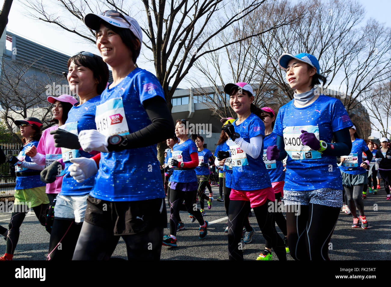 Women run past Yoyogi National Stadium during the Shibuya Omotesando ...