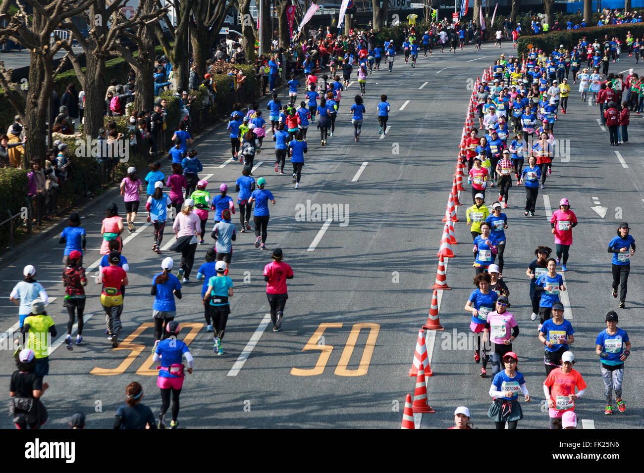 Women run past Yoyogi National Stadium during the Shibuya Omotesando ...
