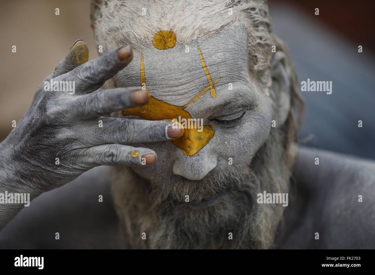 Kathmandu, Nepal. 6th Mar, 2016. A Hindu Sadhu or holy man smears color ...