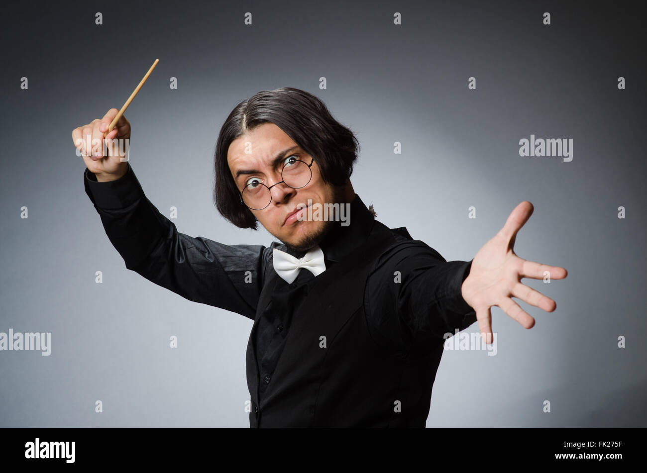 Funny conductor in musical concept Stock Photo - Alamy