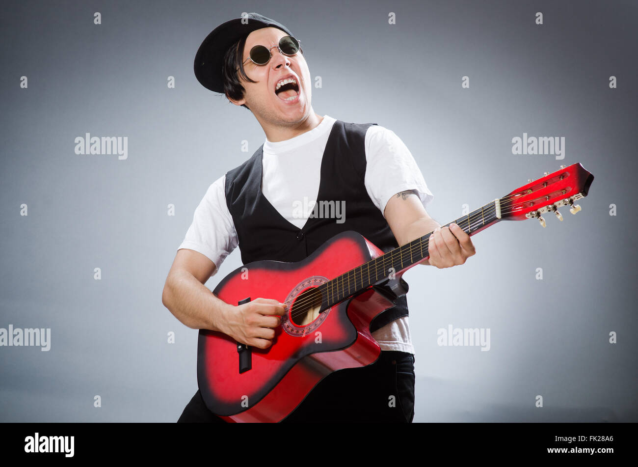 Funny guitar player in musical concept Stock Photo - Alamy