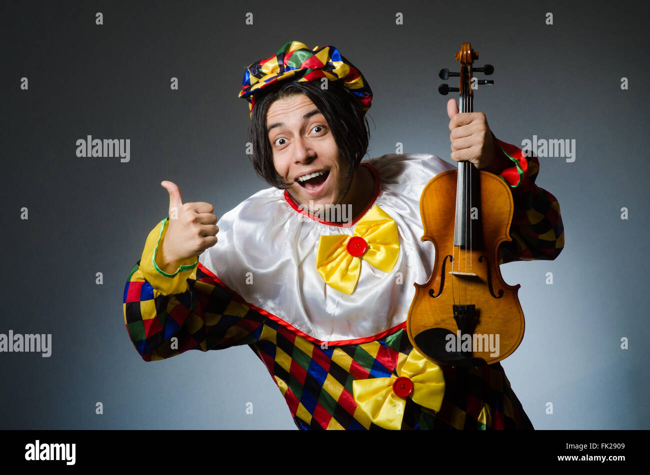 Funny violin clown player in musical concept Stock Photo - Alamy