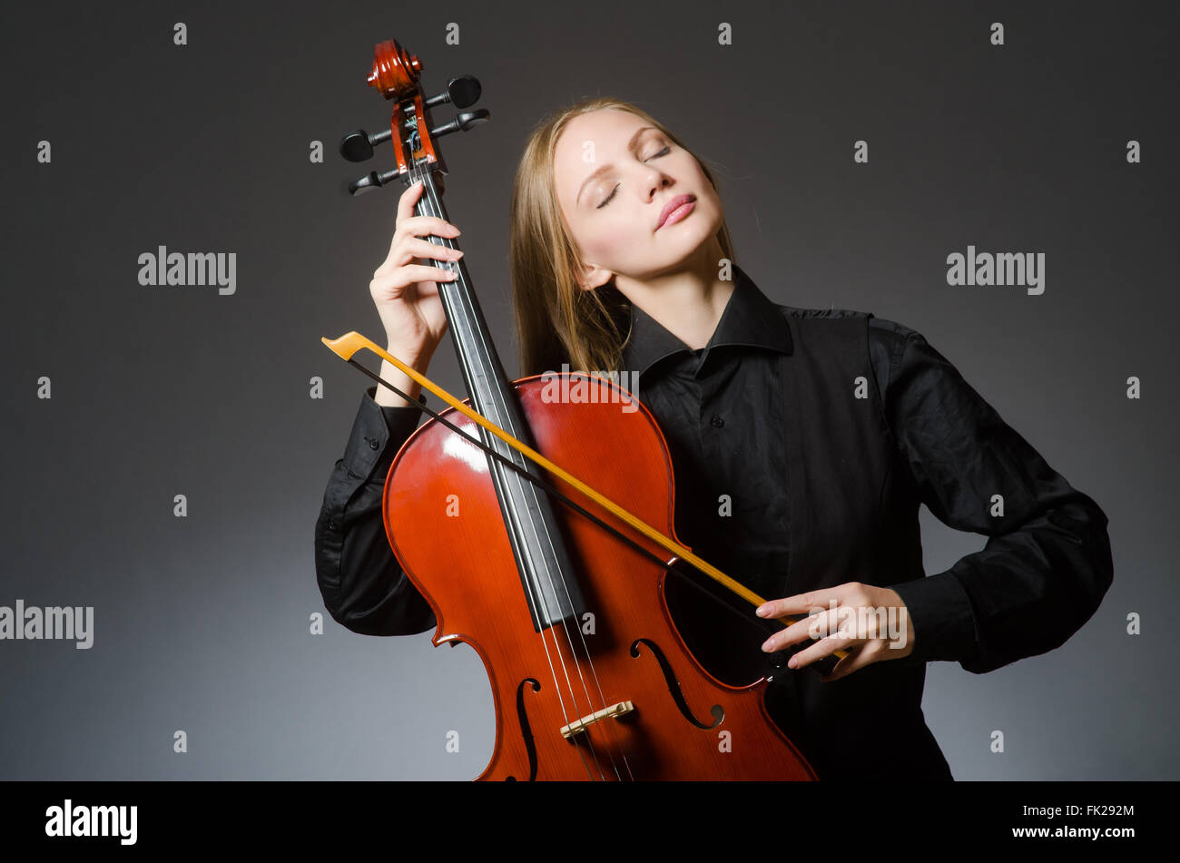 Woman playing classical cello in music concept Stock Photo - Alamy
