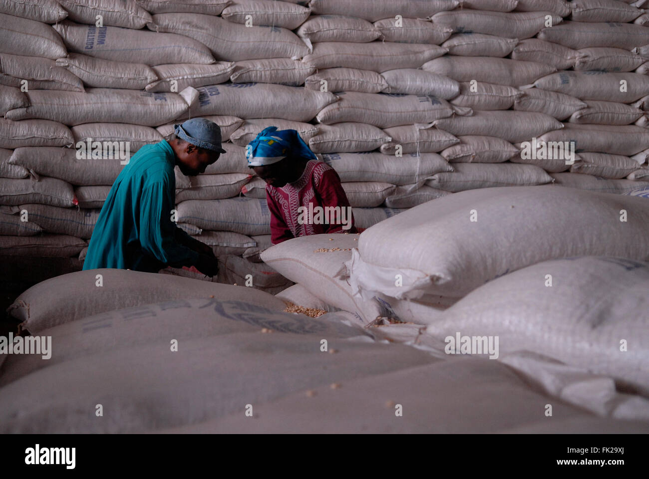 Employees of the World Food Programme WFP stack large sacks of basic ...