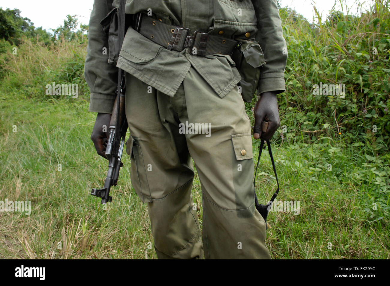 A FARDC Congolese government soldier holds a slingshot as he stands ...