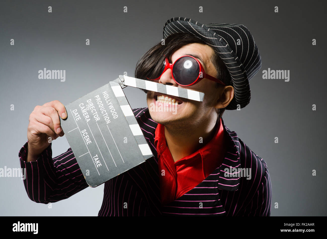Funny man with movie board Stock Photo - Alamy