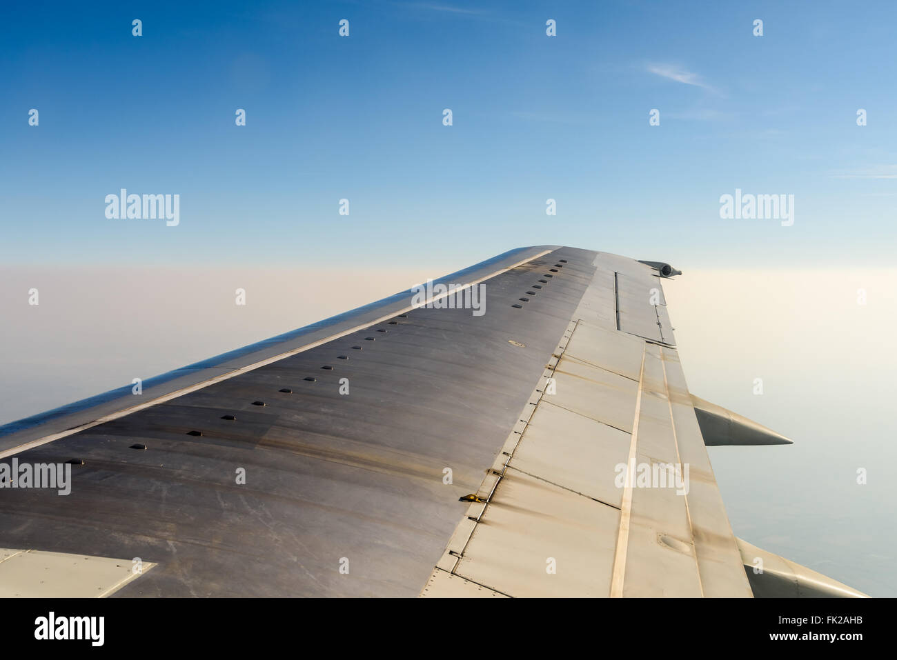 Window View Of Airplane Wing Flying Above Clouds Stock Photo - Alamy