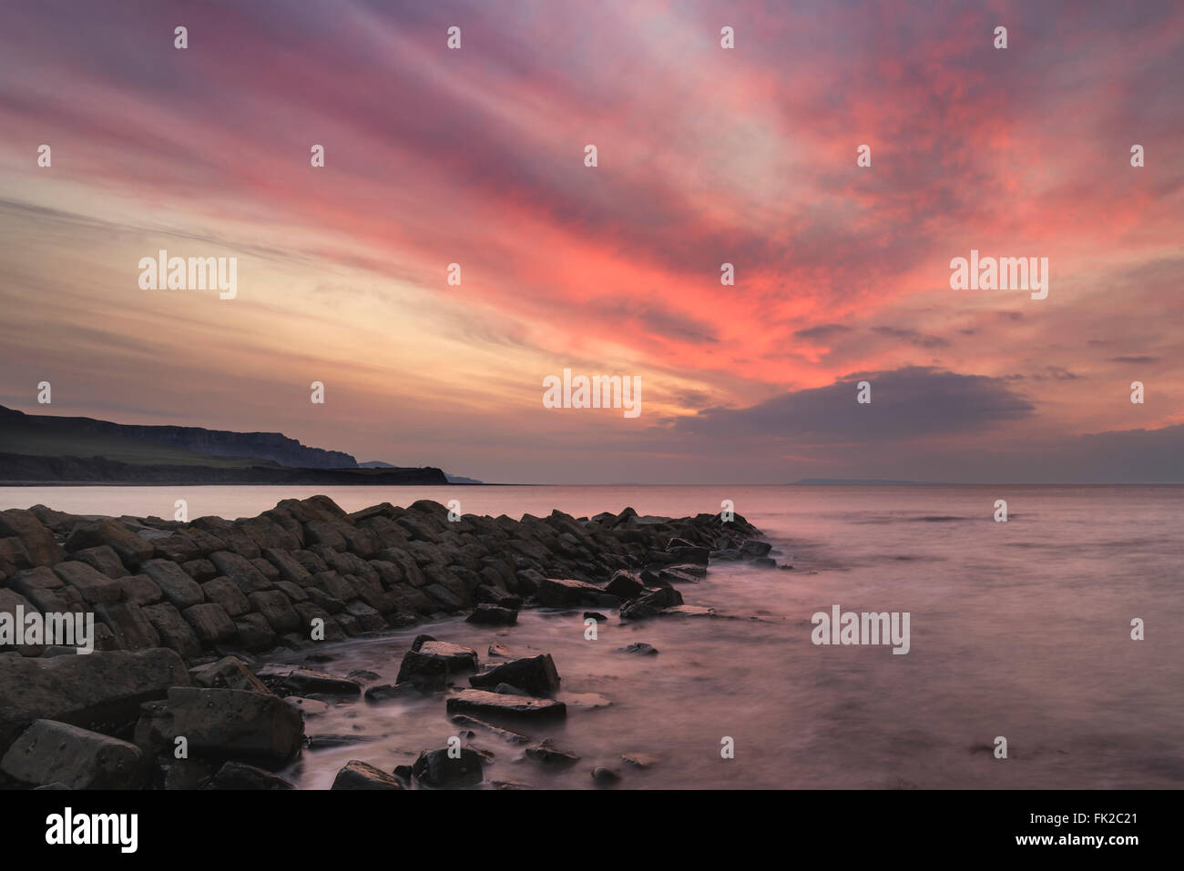 Stunning sunset landscape image of rocky coastline in Dorset England ...