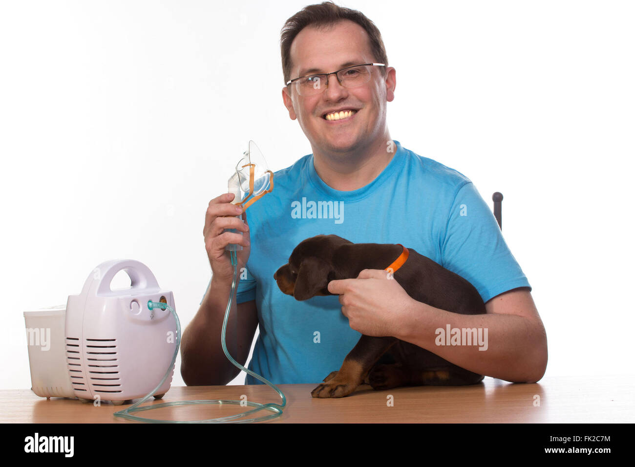 Happy adult doctor using nebulizer mask for respiratory inhaler dog ...