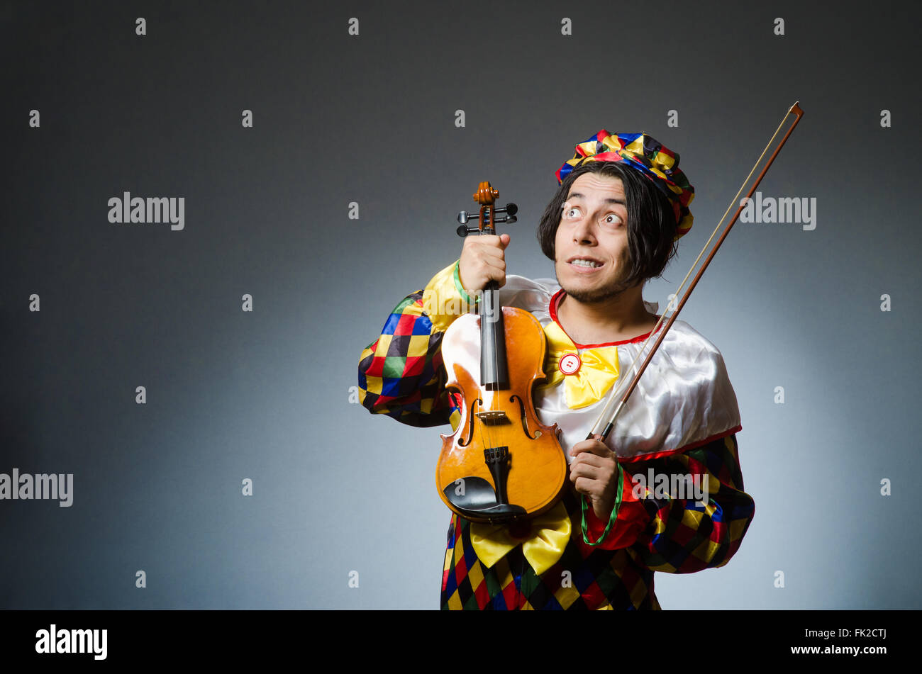 Funny violin clown player in musical concept Stock Photo - Alamy
