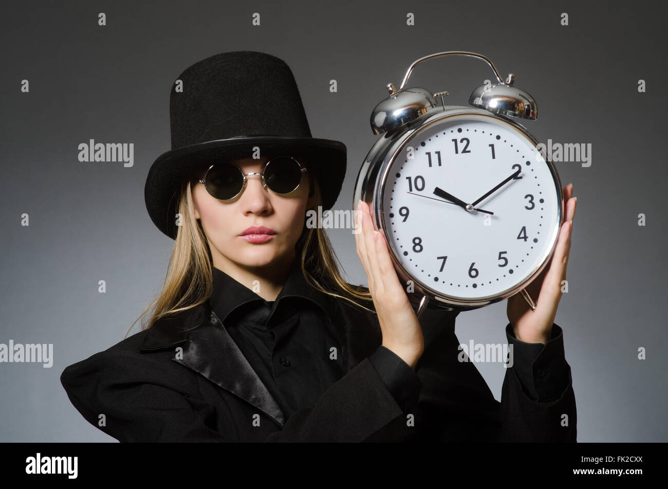 Woman with clock in business concept Stock Photo - Alamy
