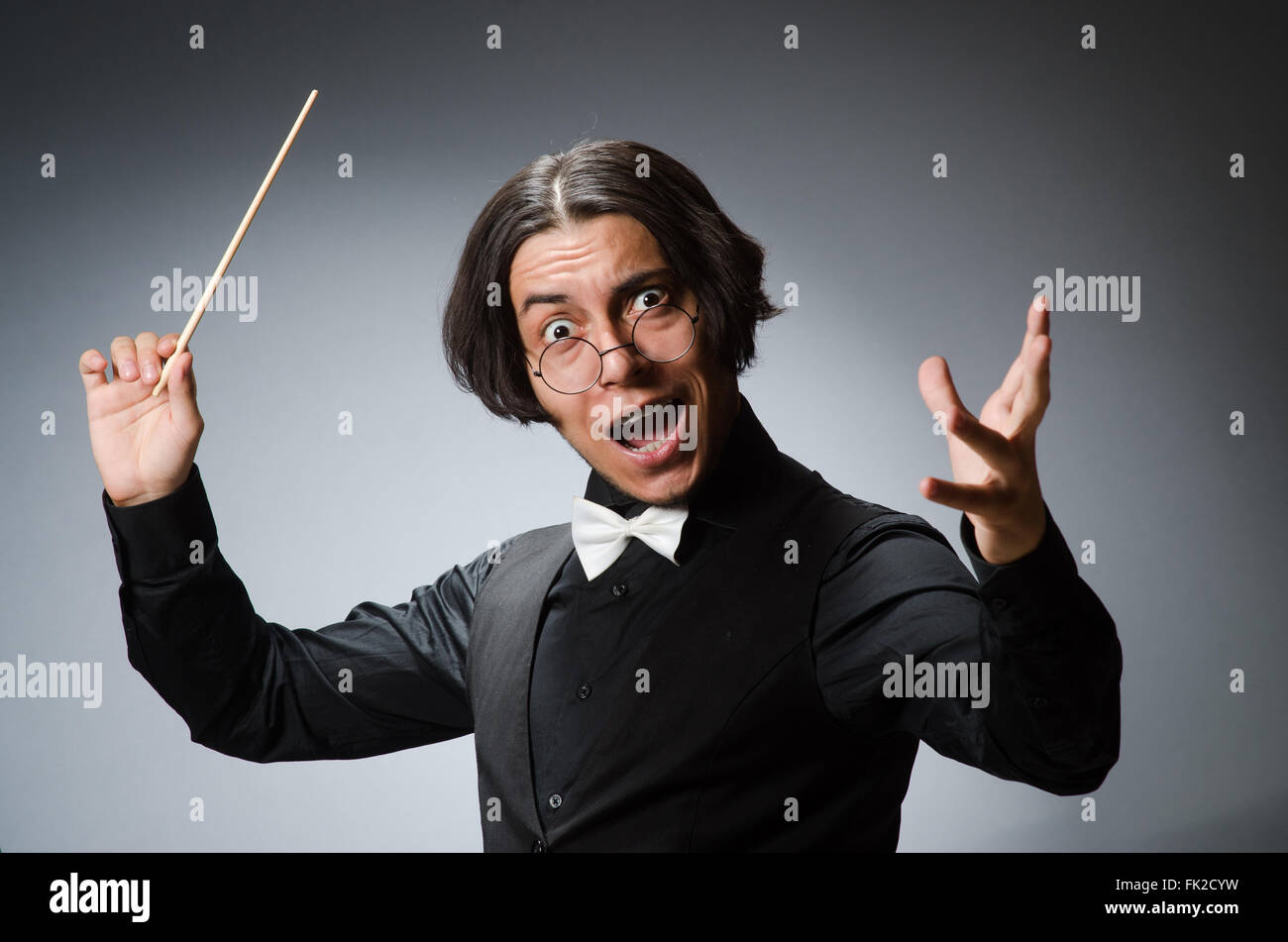 Funny conductor in musical concept Stock Photo - Alamy