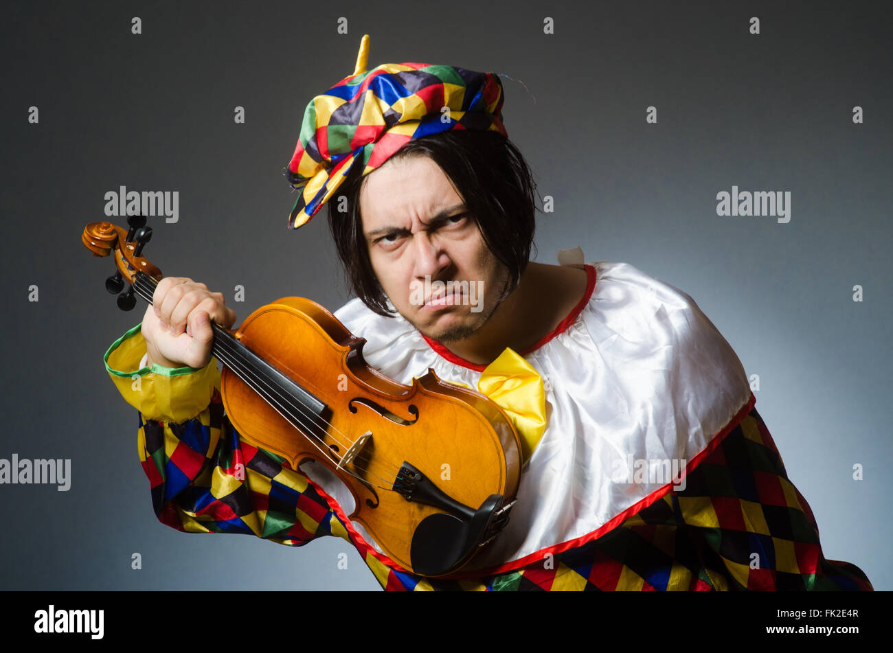 Funny violin clown player in musical concept Stock Photo - Alamy