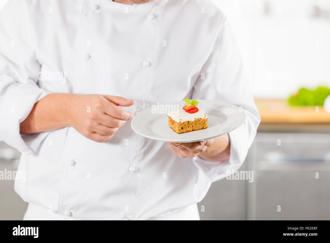 Chef holding dessert cake with strawberry Stock Photo - Alamy