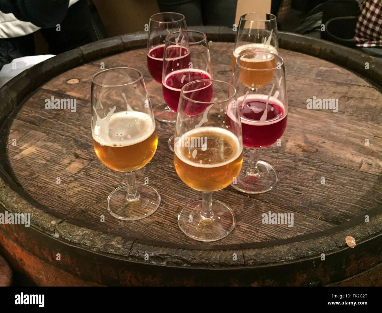 Glasses of Gueuze and Kriek lambic beers on a barrel, during a ...