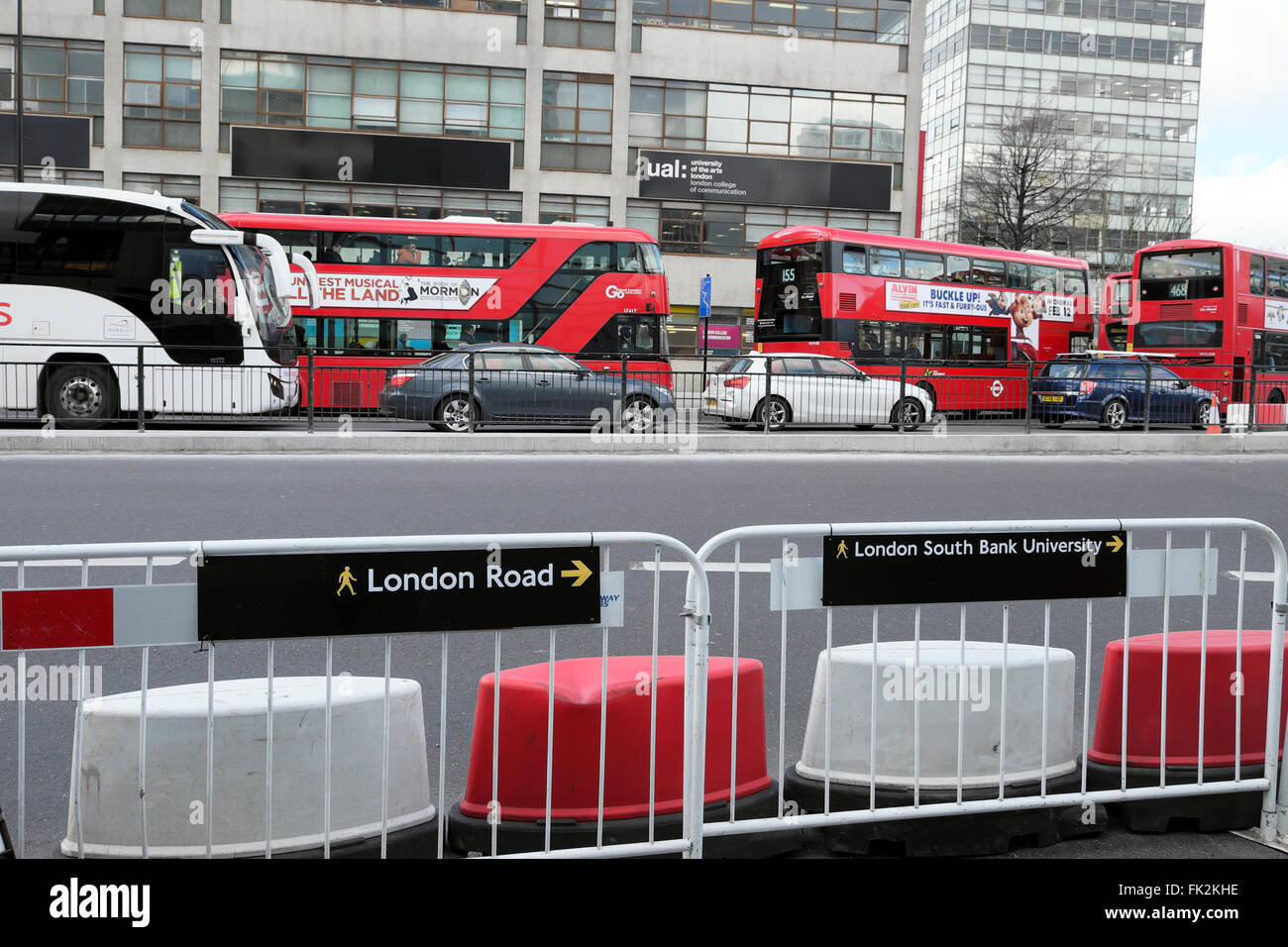 Traffic congestion with buses and cars in one lane next to empty road ...