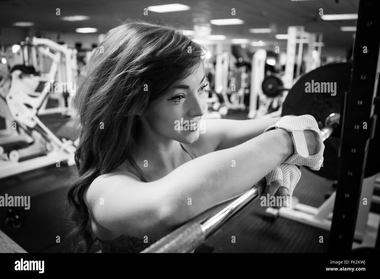Young and beautiful female fitness competitor on a squats rack Stock ...