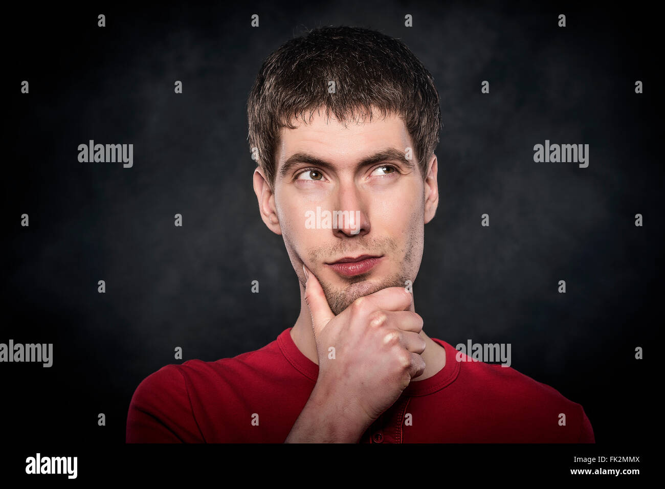 Young man thinking Stock Photo - Alamy