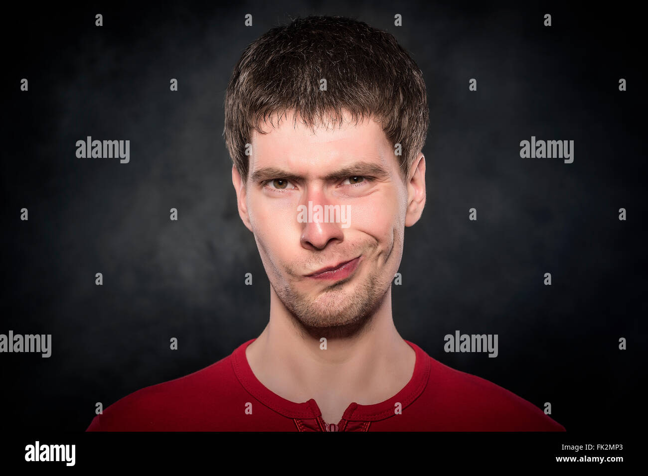 Skeptical young man Stock Photo - Alamy