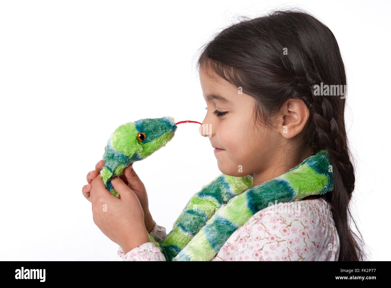 Little Girl Is Talking To A Toy Snake on white background Stock Photo ...