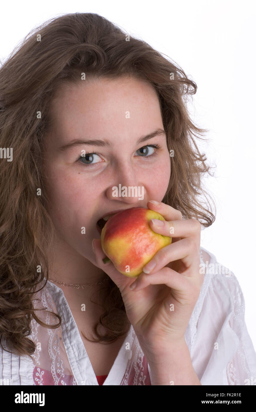 Teenage Girl Eating An Apple On White Background Stock Photo - Alamy