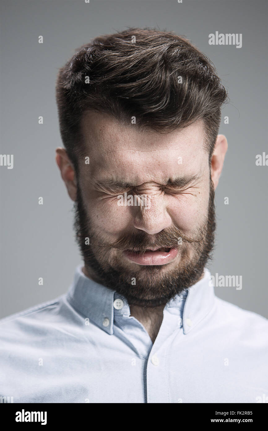 The crying man with tears on face closeup on blue background Stock ...