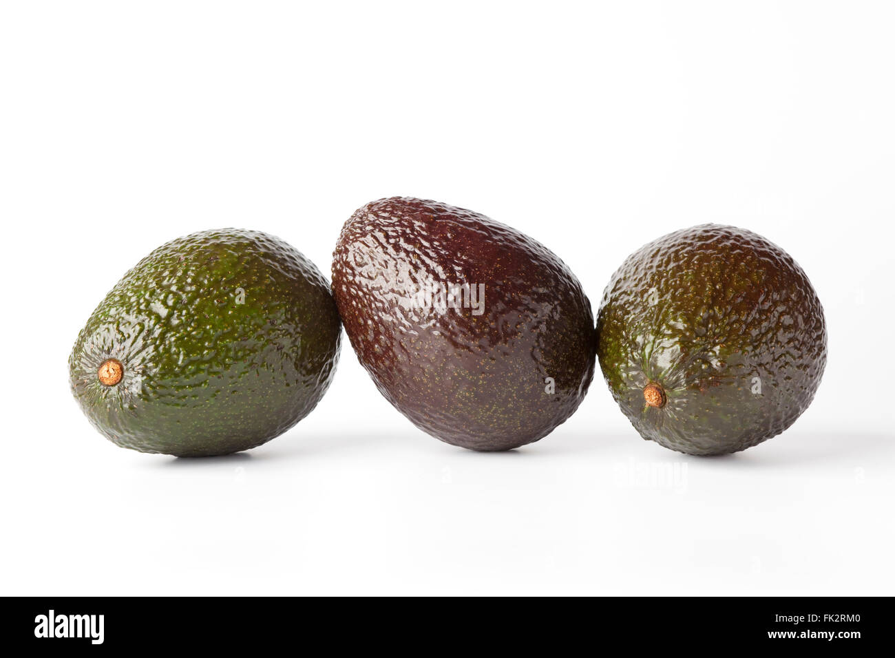 Three fresh whole avocado's in a row on white background Stock Photo ...