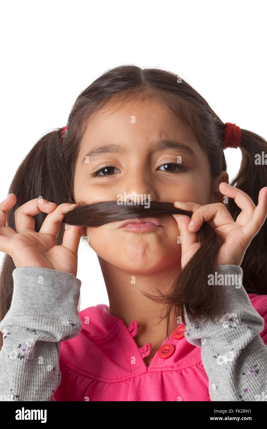 Little girl is making a moustache of her hair on white background Stock ...