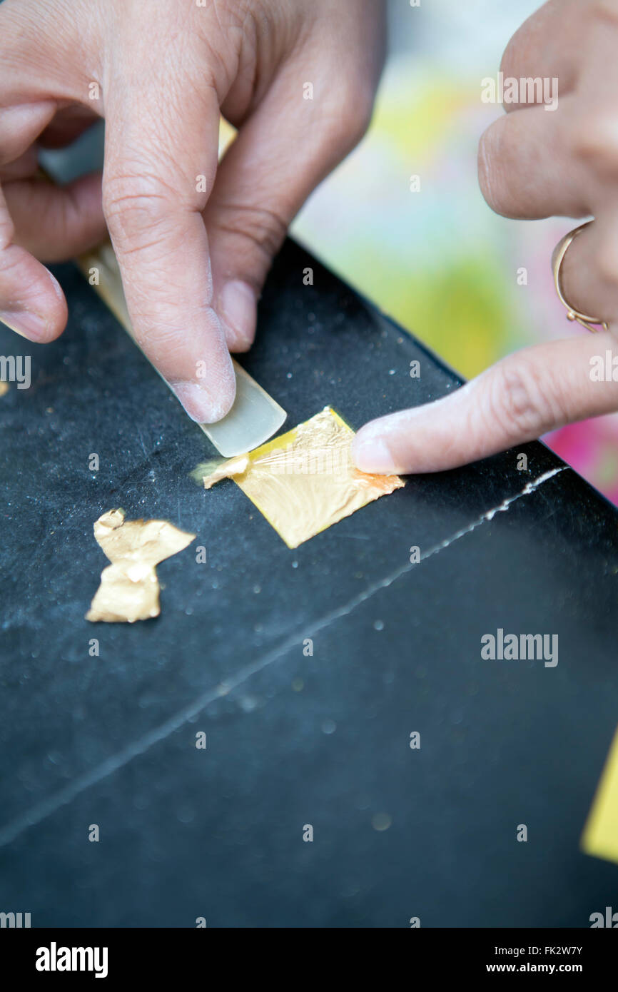 Gold leaf being worked in a factory in Mandalay Stock Photo - Alamy
