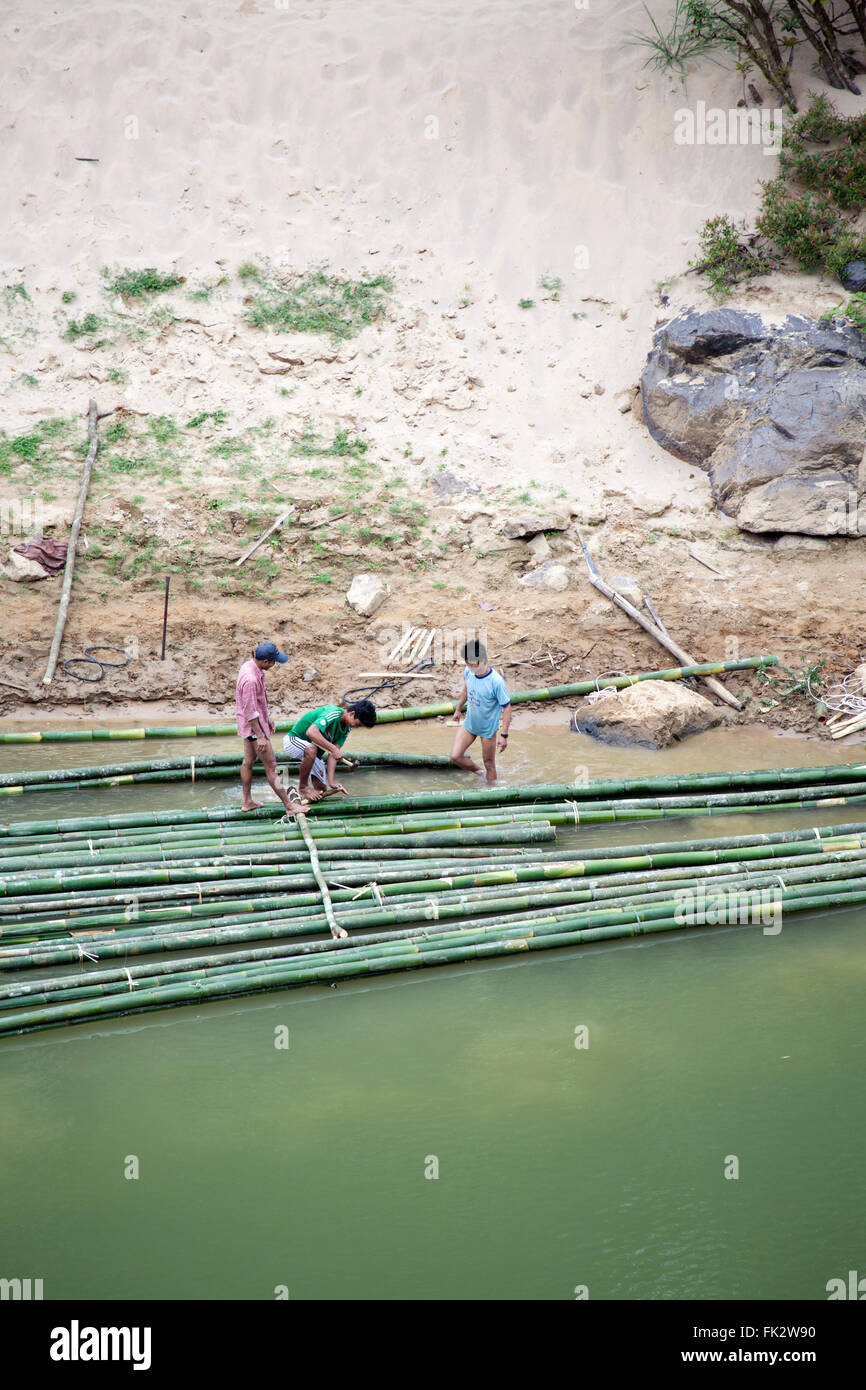 Locals making a bamboo raft Stock Photo - Alamy