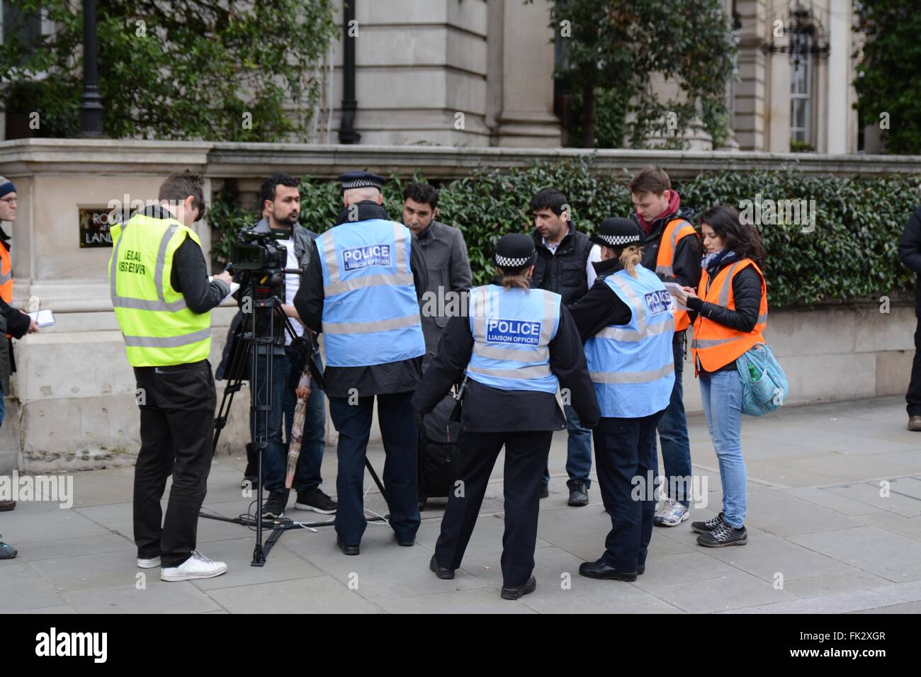 London, UK. 6th March 2016. Police officers, surrounded by Legal ...